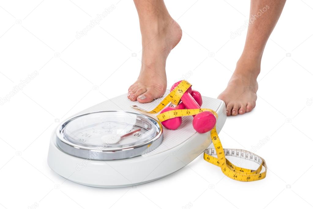Woman Stepping On Weight Scale — Stock Photo © AndreyPopov #97125918