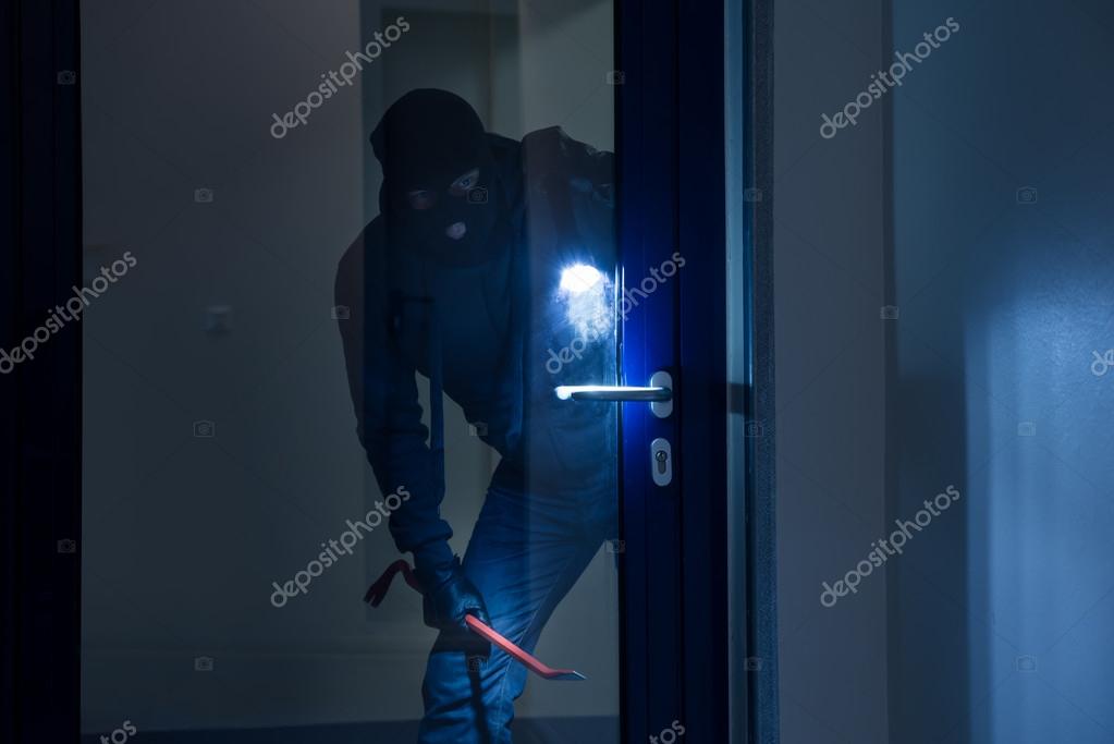 Thief Trying To Break Door Stock Photo by ©AndreyPopov 97931270