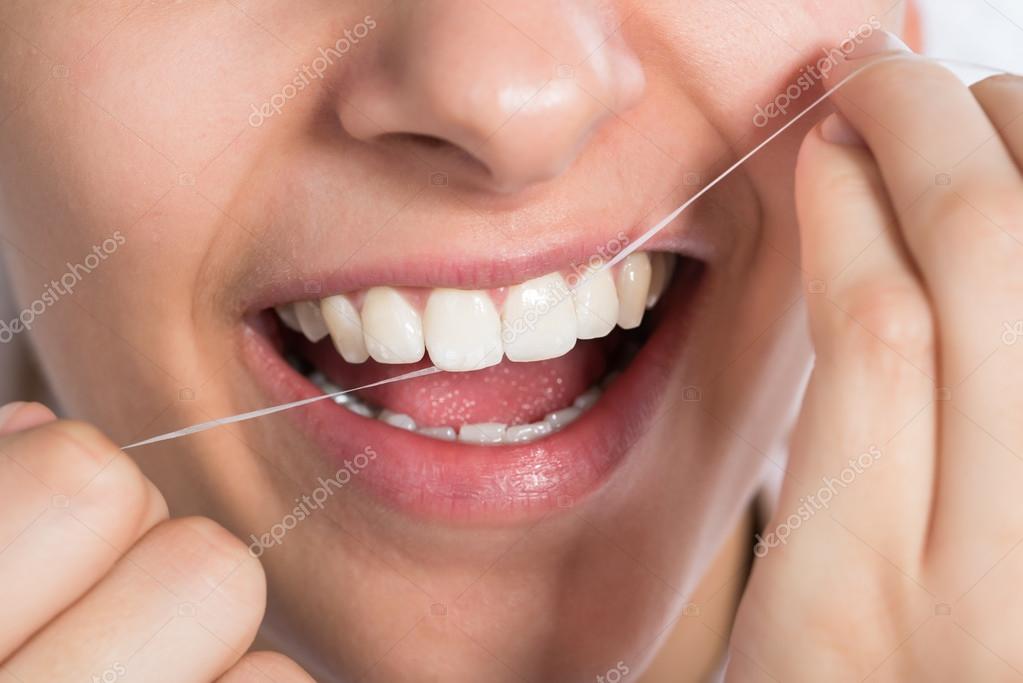 Woman Flossing Teeth At Home — Stock Photo © AndreyPopov #97931894