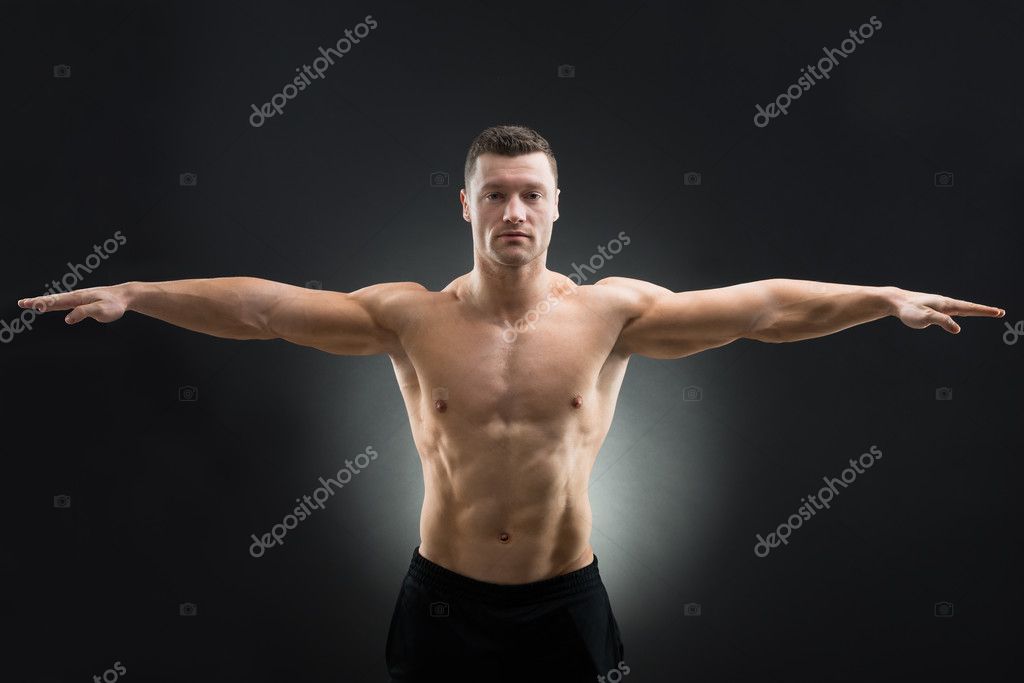 Confident Muscular Man Standing Stock Photo by ©AndreyPopov 97932760