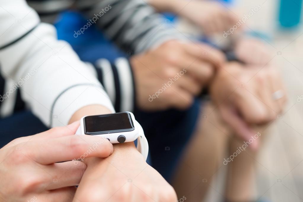 Group of people using smartwatch together Stock Photo by ©leungchopan ...