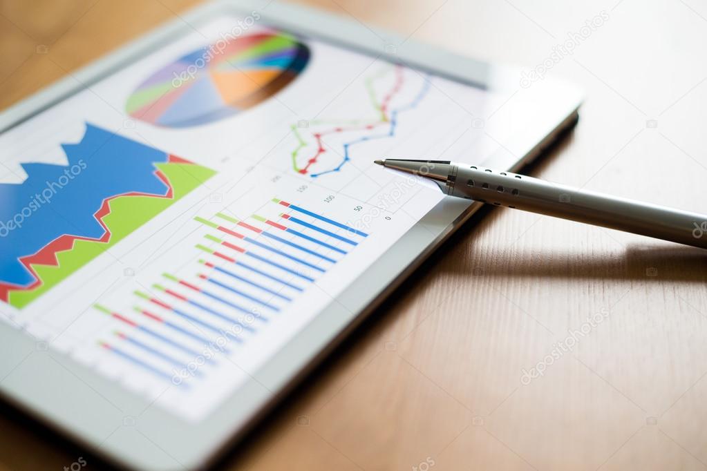 Digital tablet with business charts on a screen — Stock Photo ...