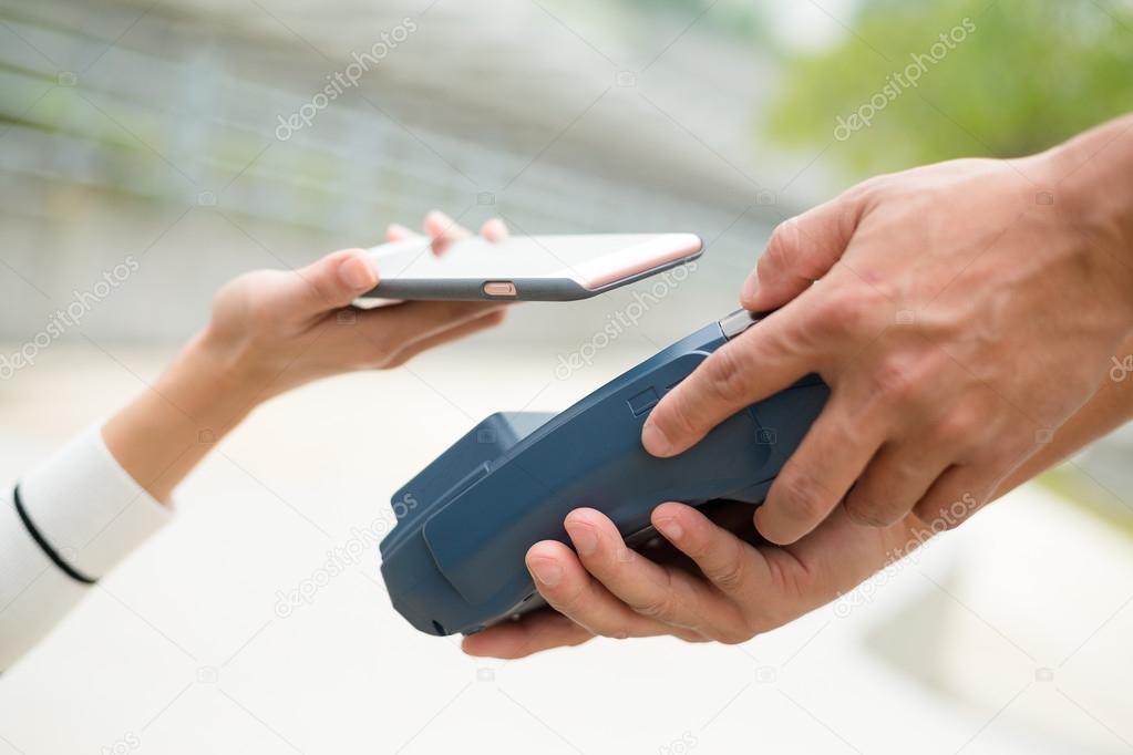 Woman using smart phone for paying the bill — Stock Photo © leungchopan ...