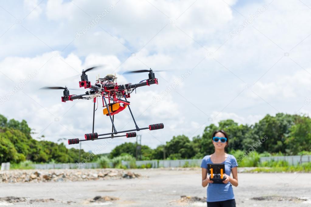 Woman controlling drone quadcopter — Stock Photo © leungchopan #115688960