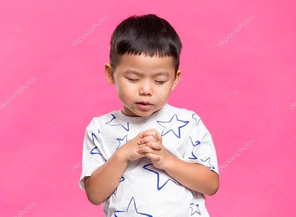 Little boy praying Stock Photo by ©leungchopan 121042860