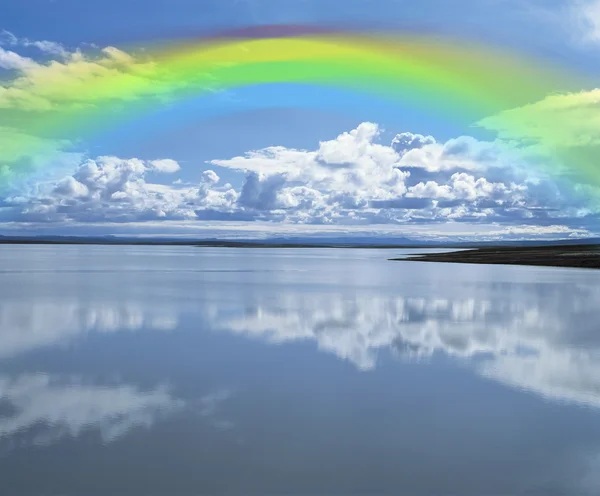 Rainbow over calm lake — Stock Photo © londondeposit #138141382