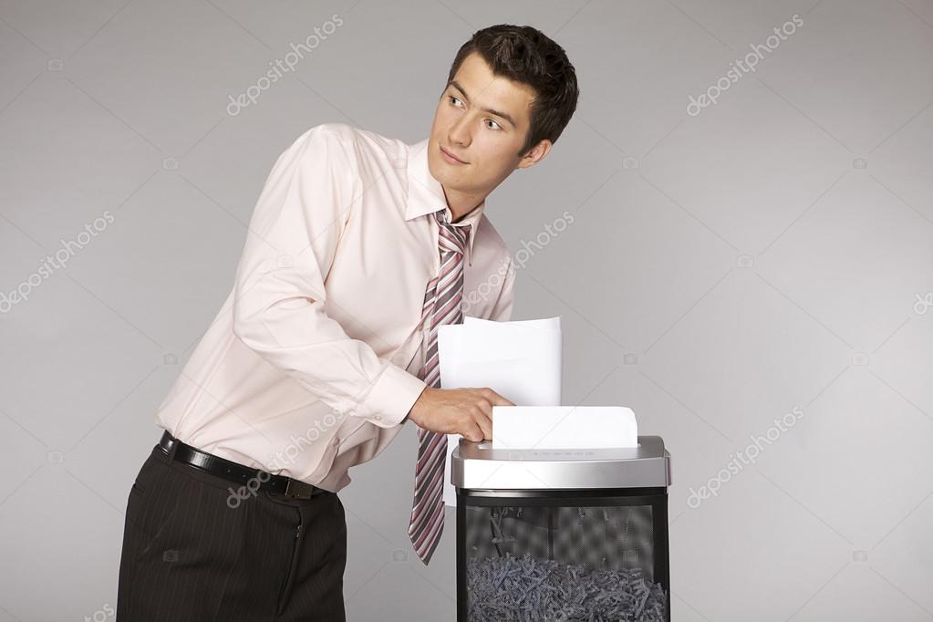 Person Shredding Paper