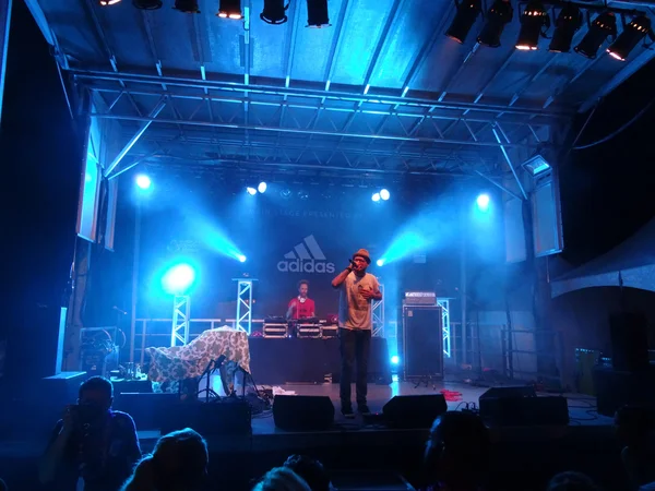 MC Yogi holds hand to heart as he preforms on stage with DJ Dre - Stock ...