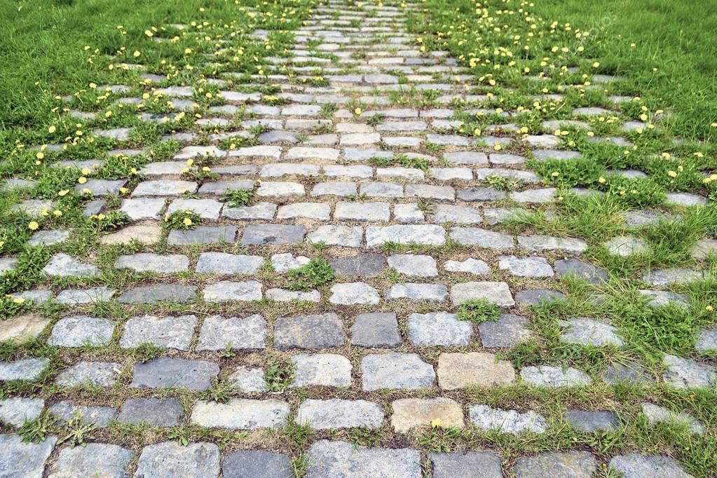 Stone brick road Stock Photo by ©yurizap 106061636