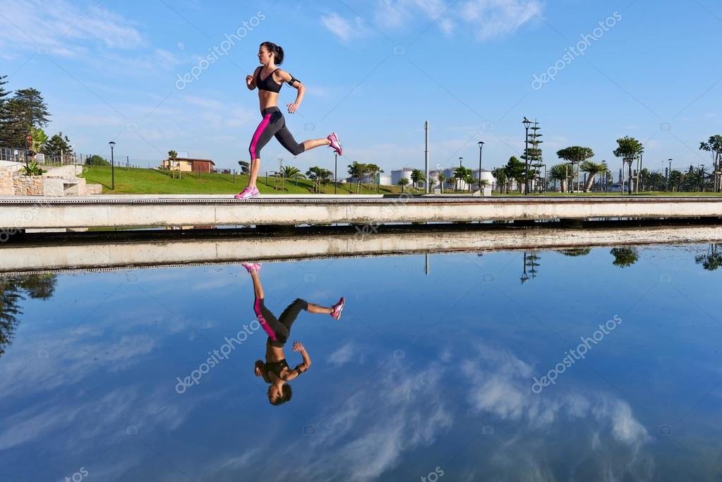 Woman running over bridge Stock Photo by ©Daxiao_Productions 74951261