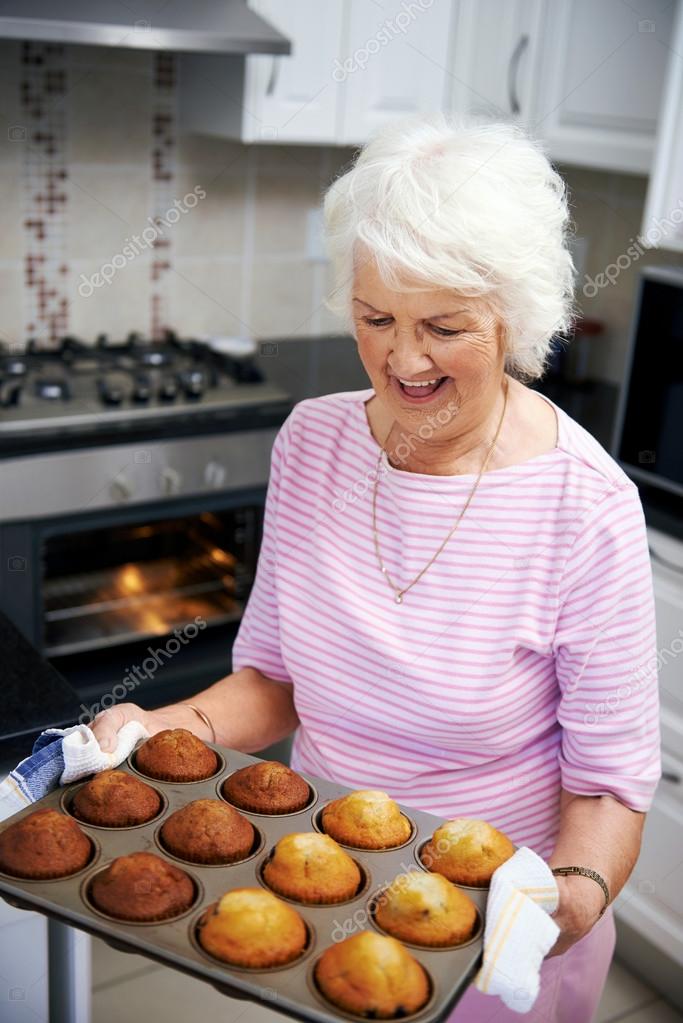 Old lady taking muffins out of oven Stock Photo by ©Daxiao_Productions ...