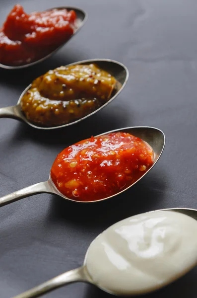 Different types of condiments on spoons — Stock Photo © Daxiao ...