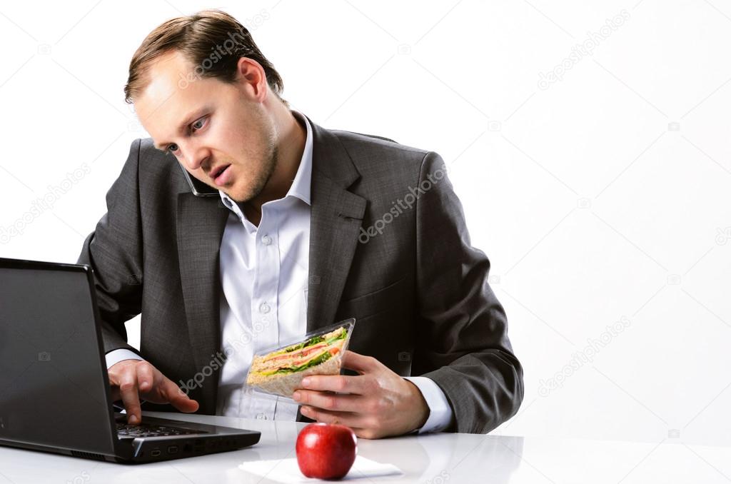 Multi tasking businessman works through lunch — Stock Photo © Daxiao ... Multi tasking businessman works through lunch — Stock Photo © Daxiao ...