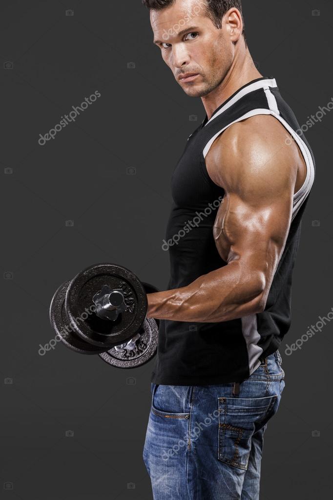 Muscle man lifting weights Stock Photo by ©ikostudio 62272221