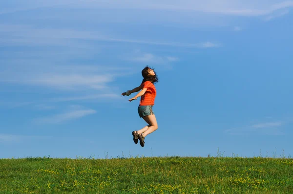 Jumping happy emotion woman on grass and sky backgrounds - Stock Image ...