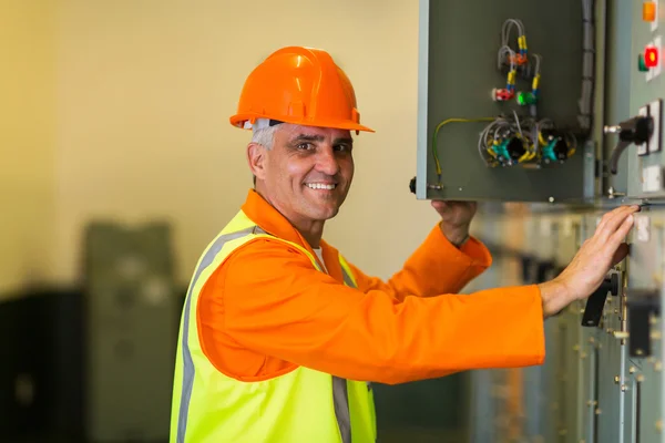 Electrician checking industrial control box - Stock Image - Everypixel