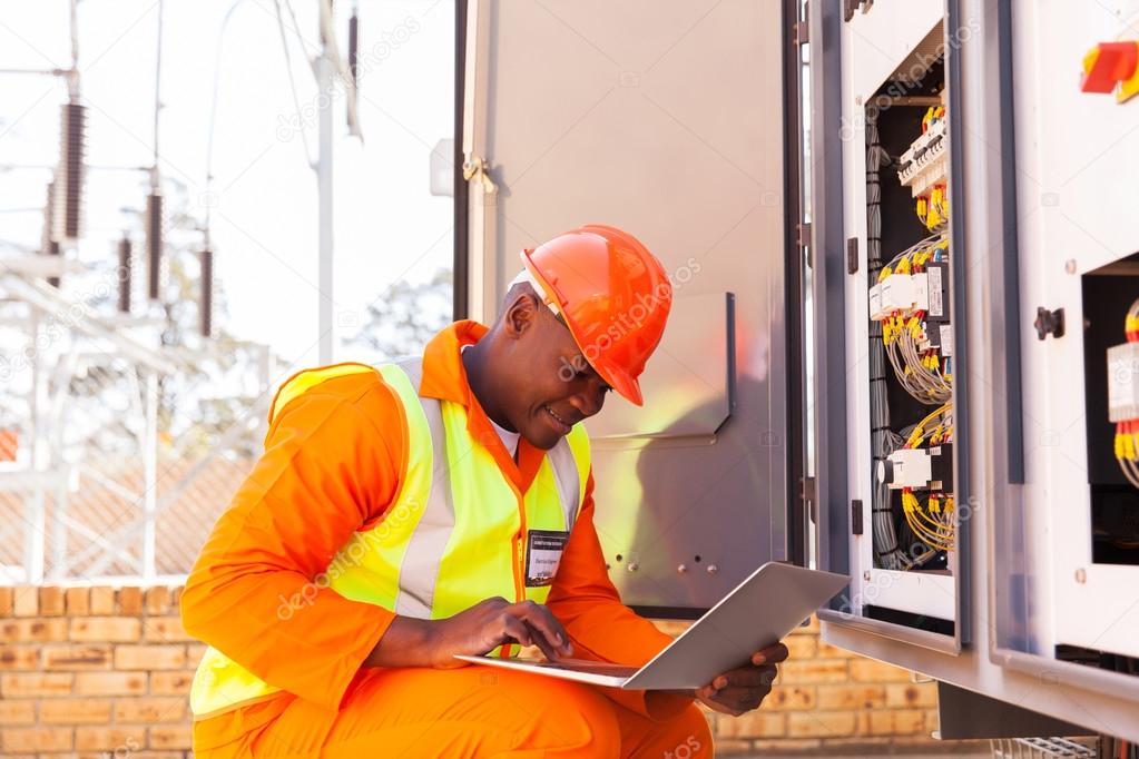 African electrical engineer working on laptop — Stock Photo ...