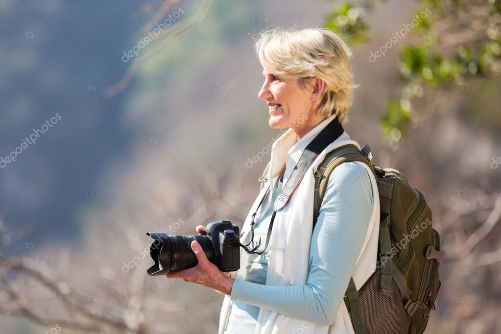 Woman hiking with dslr camera — Stock Photo © michaeljung #81840904