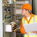 Engineer with laptop in machine control room Stock Photo by ...