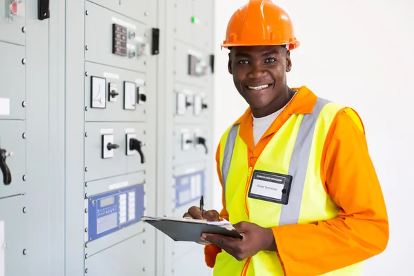 Engineer with laptop in machine control room Stock Photo by ...