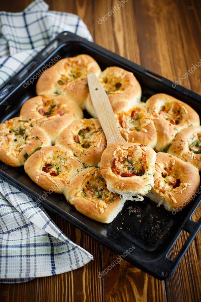 Mini pizzas baked stuffed with cheese Stock Photo by ©Rawlik 102305816