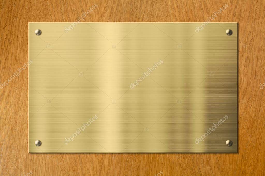 Gold or brass metal plaque on wood background — Stock Photo © Andrey ...