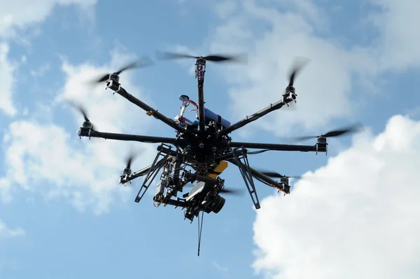 Octocopter drone with digital camera in flight, used toning of the ...