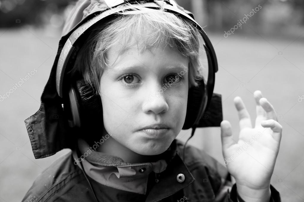 Cute autistic boy with headphones Stock Photo by ©Dubova 85825468