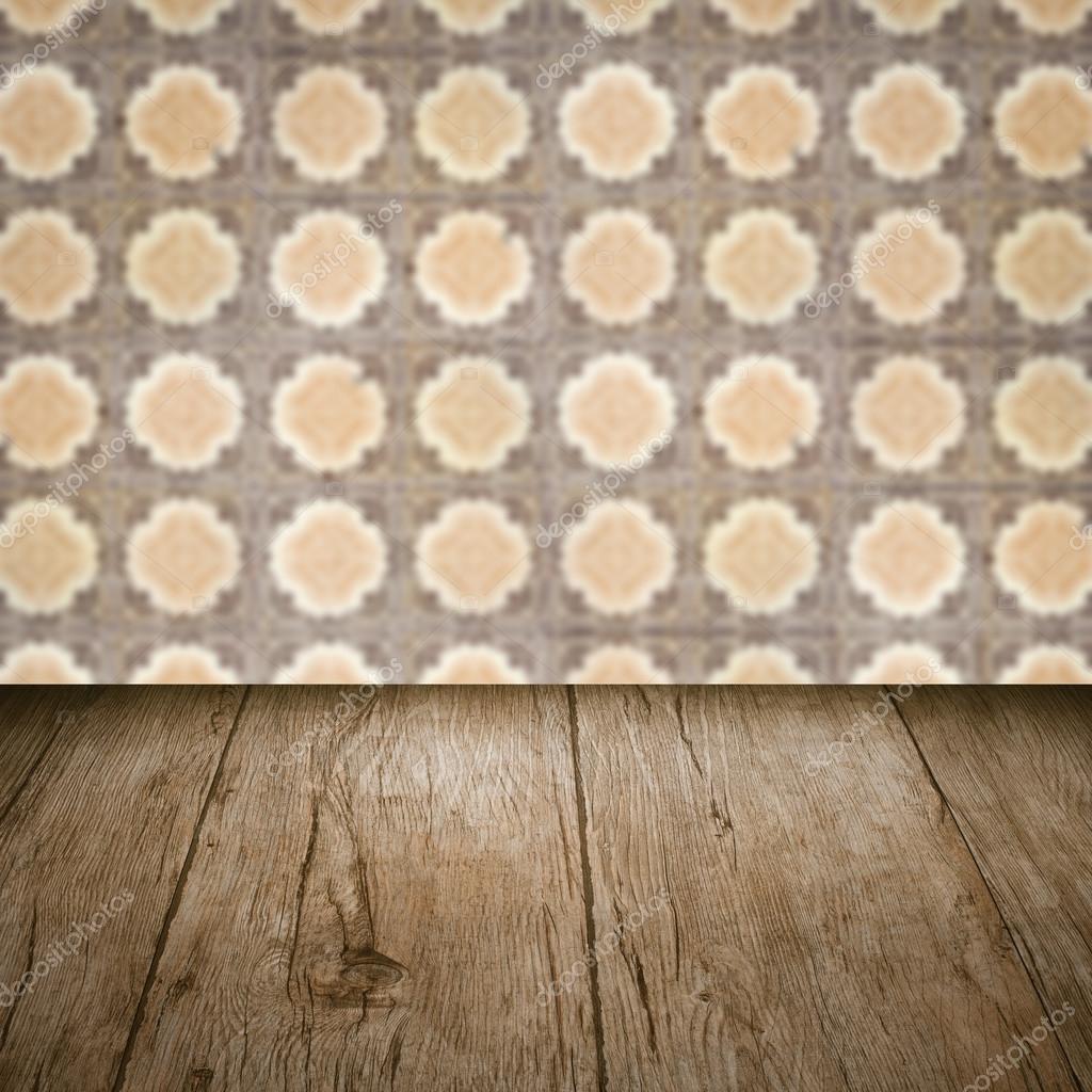 Wood table top and blur vintage ceramic tile pattern wall — Stock Photo ...