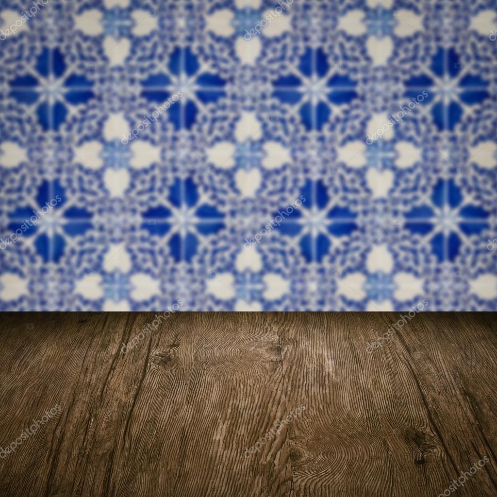 Wood table top and blur ceramic tile pattern wall — Stock Photo ...