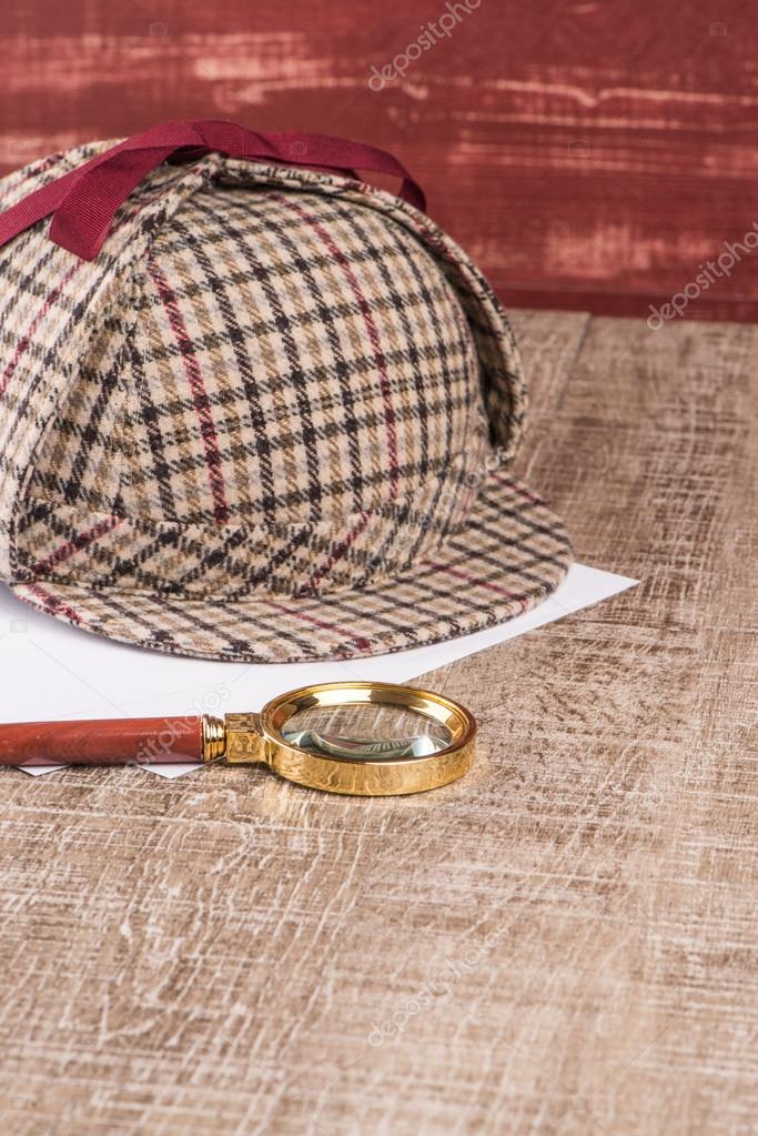 Paper sheets and magnifying glass Stock Photo by ©homydesign 72387245