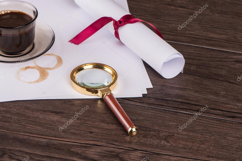 Wrapped paper sheets and magnifying glass Stock Photo by ©homydesign ...