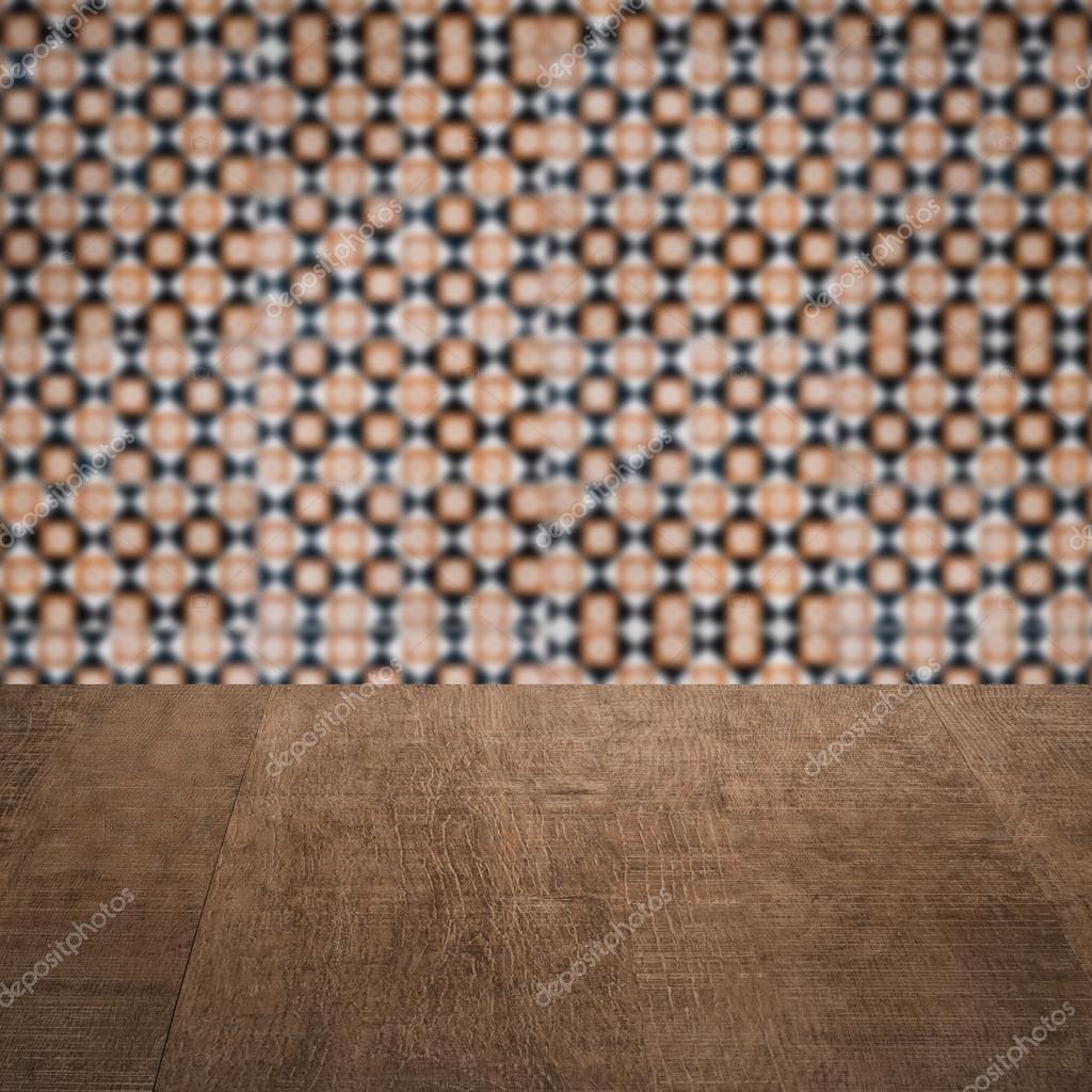 Wood table top and blur vintage ceramic tile pattern wall — Stock Photo ...