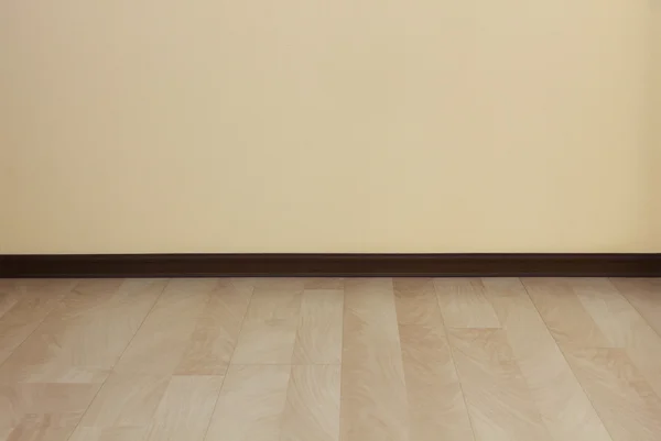 Clean wall and laminate floor taken closeup. - Stock Image - Everypixel