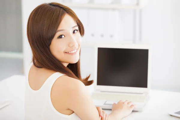 Happy young asian woman using a laptop at home - Stock Image - Everypixel