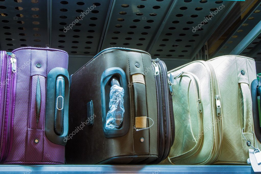 Suitcases on the shelf in the store — Stock Photo © Grigorenko #65694325