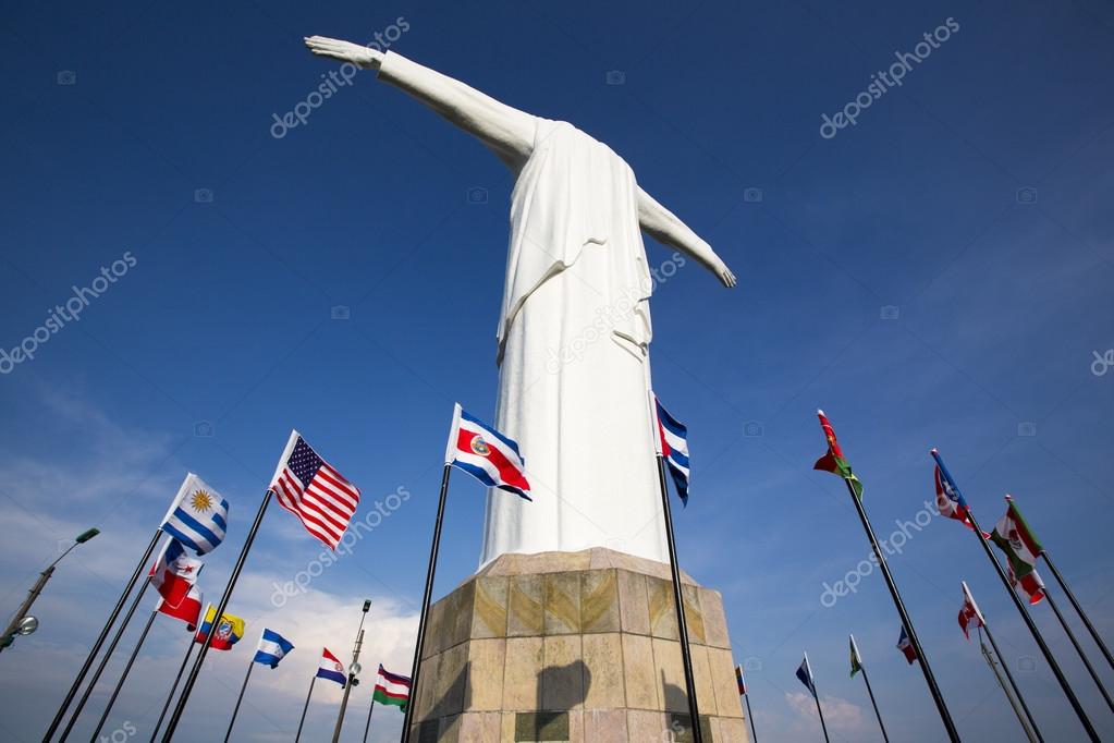 Cristo del Rey statue of Cali with world flags and blue sky, Col Stock ...
