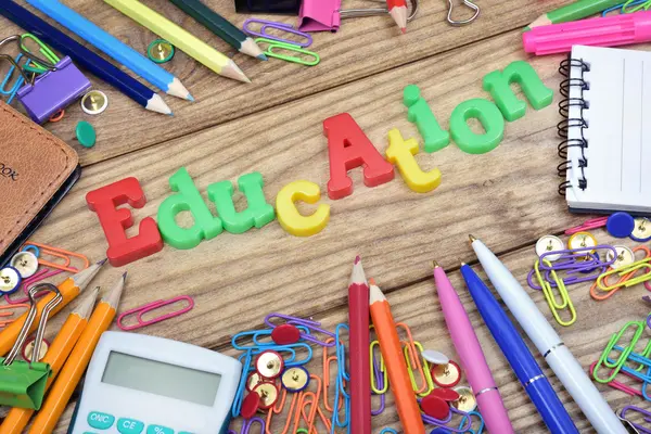 Education word and office tools on wooden table - Stock Image - Everypixel