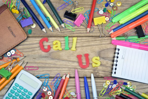 Call us word and office tools on wooden table - Stock Image - Everypixel