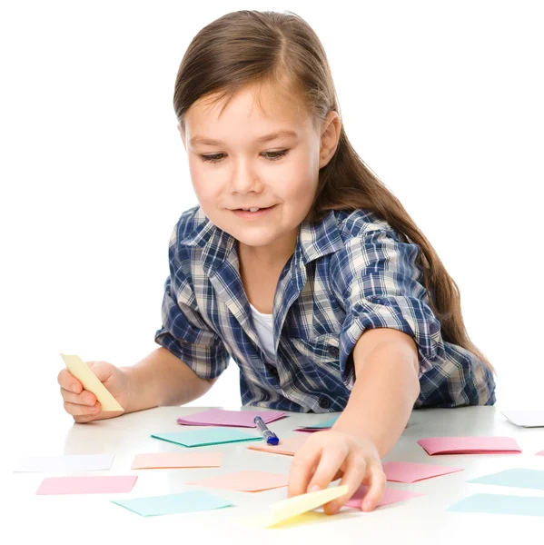 Girl is writing on color stickers using pen Stock Photo by ©Kobyakov ...