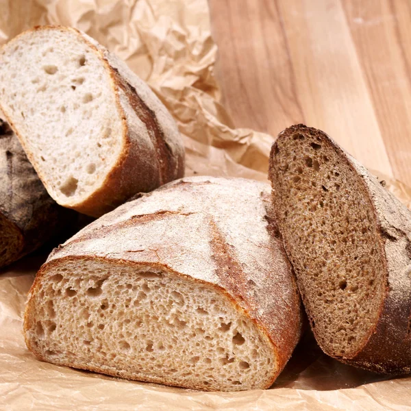 White and brown bread on backers paper - Stock Image - Everypixel