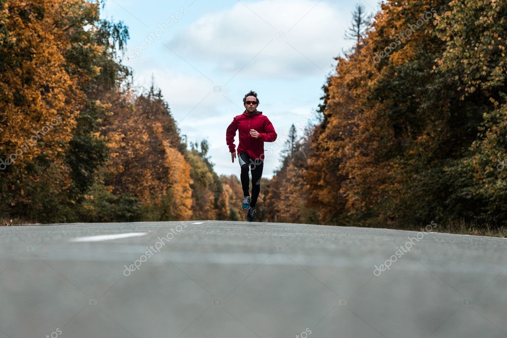 Man running down the road in the forest Stock Photo by ©mihtiander ...