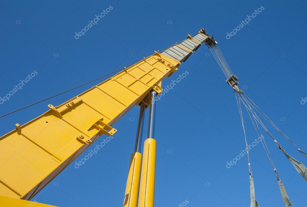 Large crane jib against blue sky background Stock Photo by ©paulvinten ...