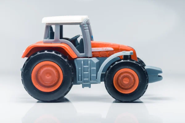 Children plastic toy tractor Stock Photo by ©Supertrooper 116495076