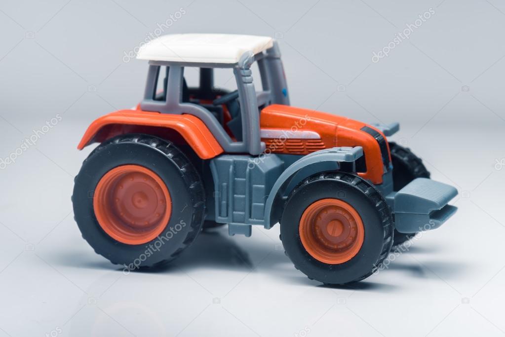 Children plastic toy tractor Stock Photo by ©Supertrooper 116495076