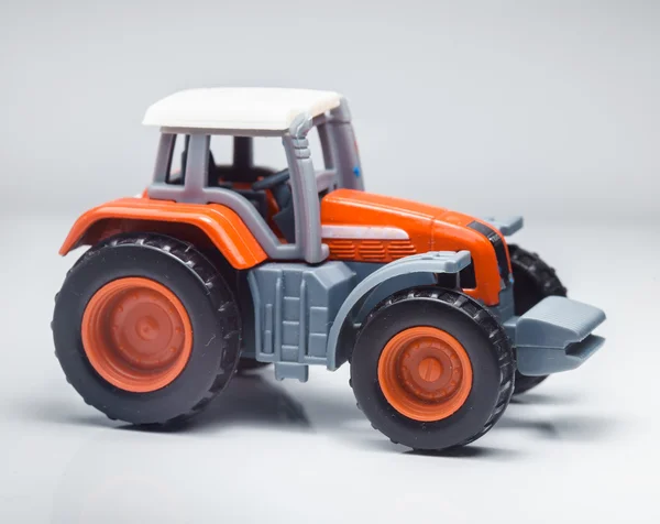 Children plastic toy tractor Stock Photo by ©Supertrooper 116495122