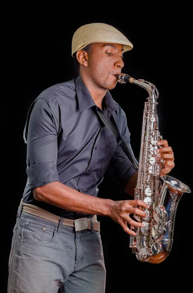 View from the side, a musician playing his saxophone. Nice and ...