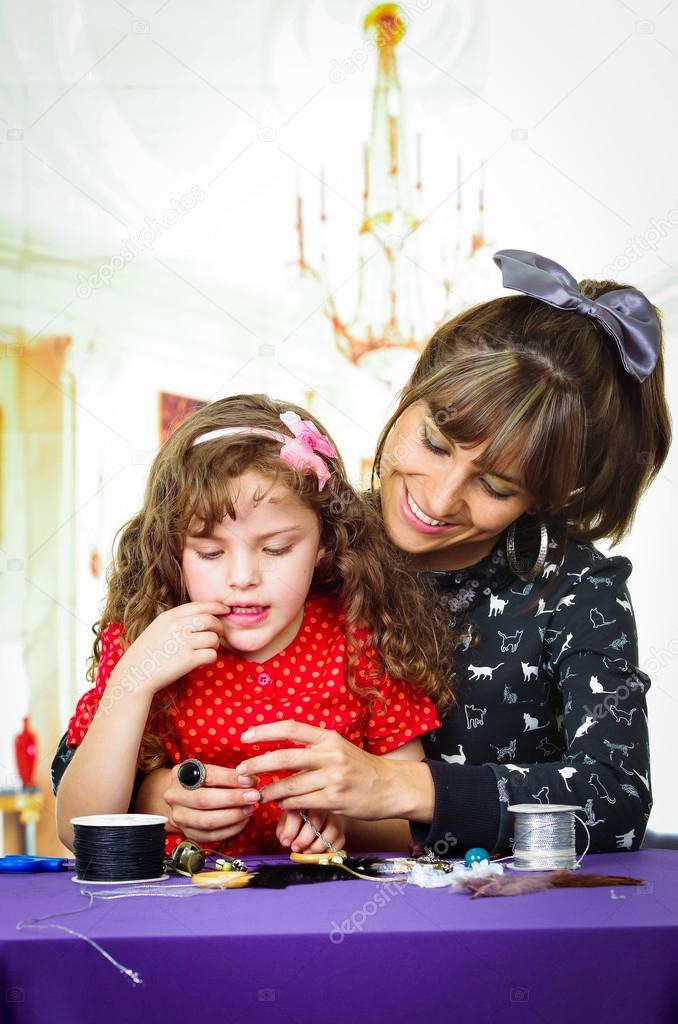 Sweet little girl making crafts with her mother Stock Photo by ...