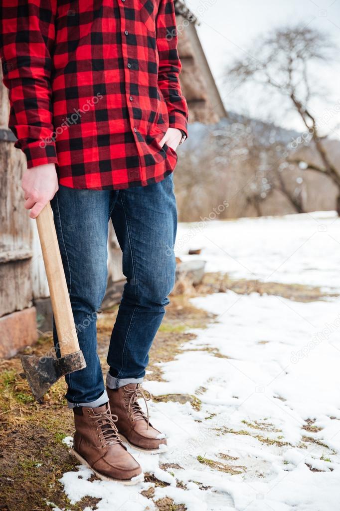 Man standing and holding axe in village Stock Photo by ©Vadymvdrobot ...