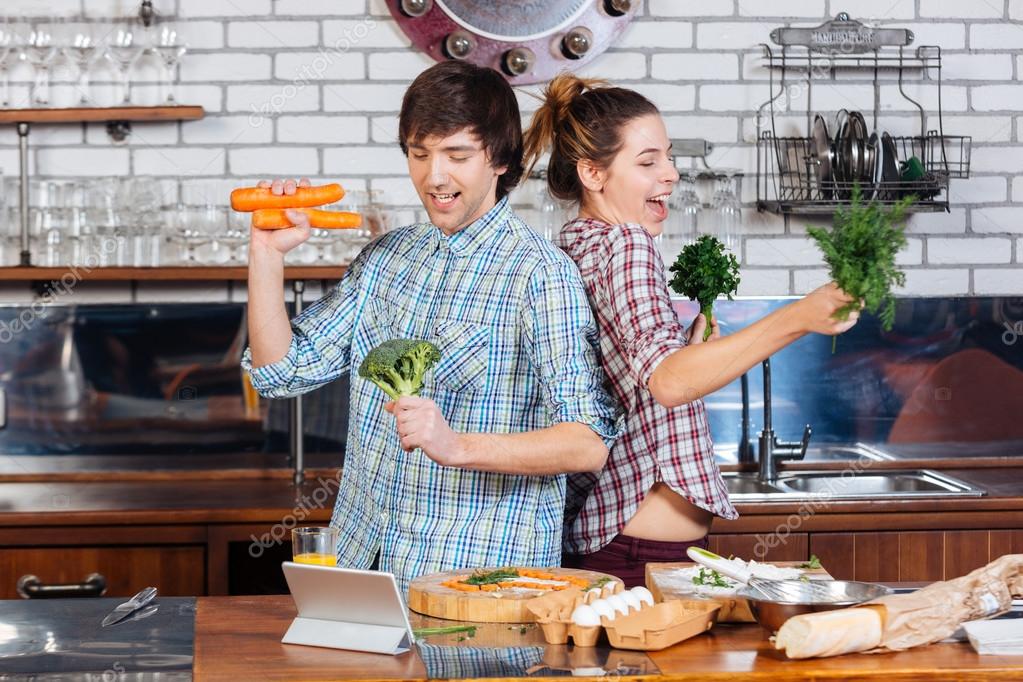 Happy couple cooking and dancing on kitchen Stock Photo by ...